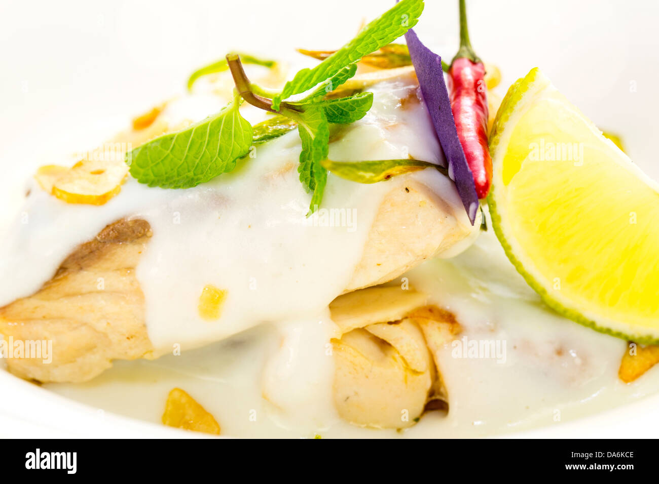 baked fish in cream sauce with lemon Stock Photo - Alamy