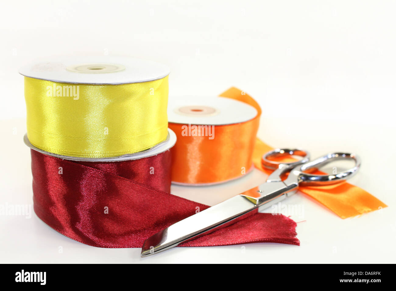 three rolls of ribbon in front of white background Stock Photo - Alamy
