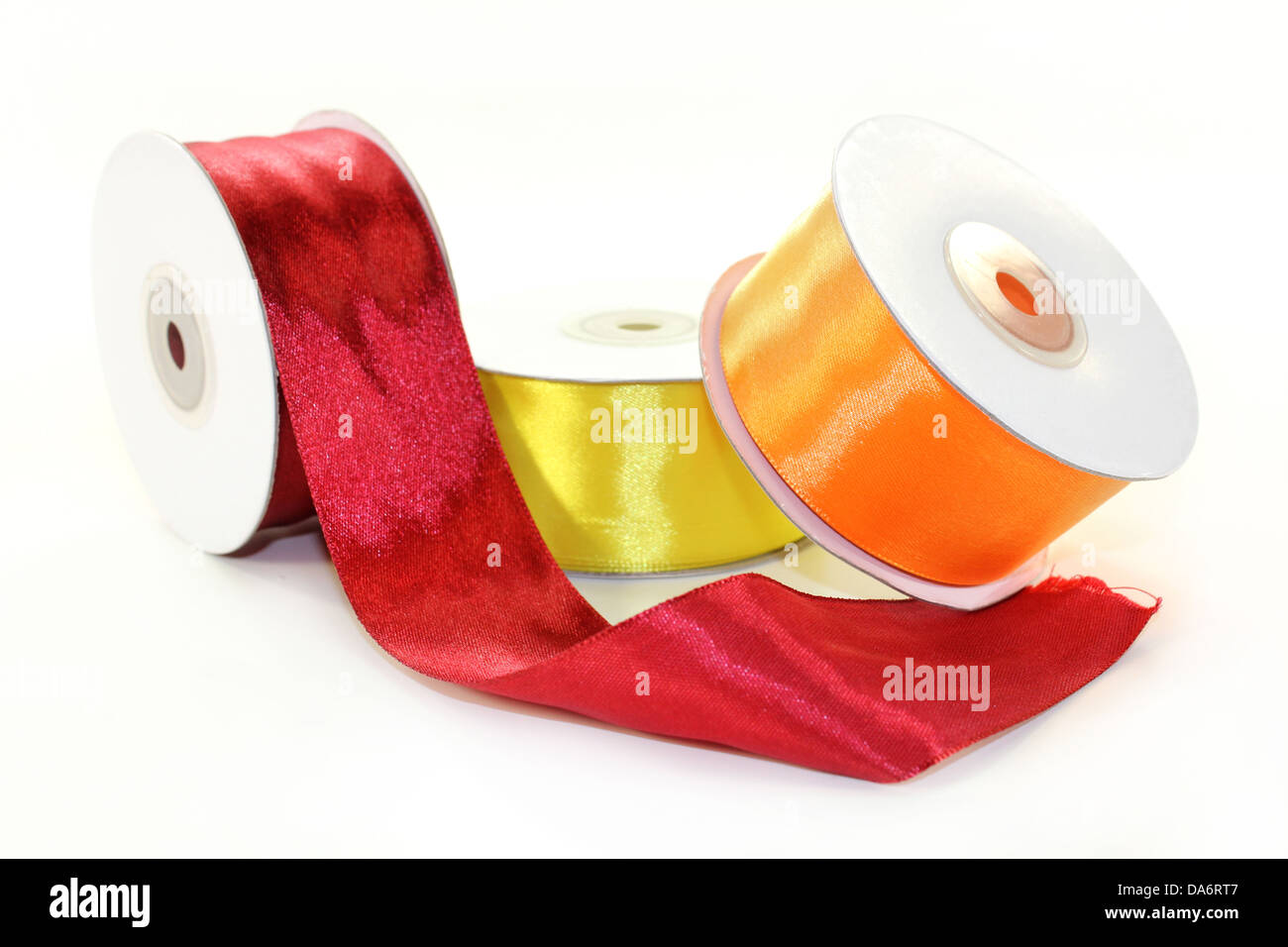 three rolls of ribbon in front of white background Stock Photo - Alamy
