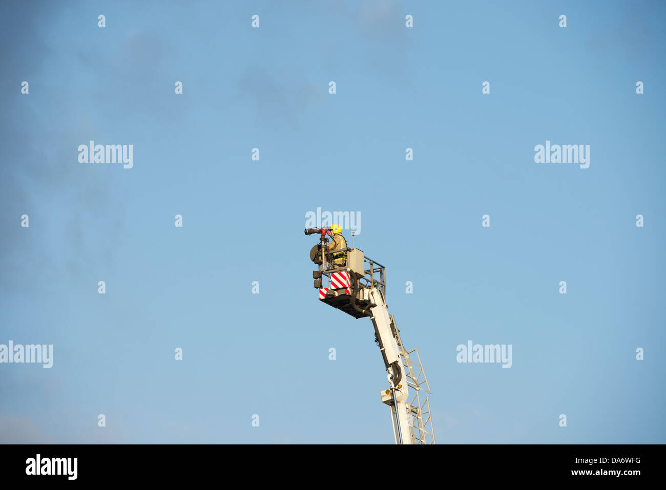 Firefighter keeps watch following a roof fire in the Hydro Arena ...
