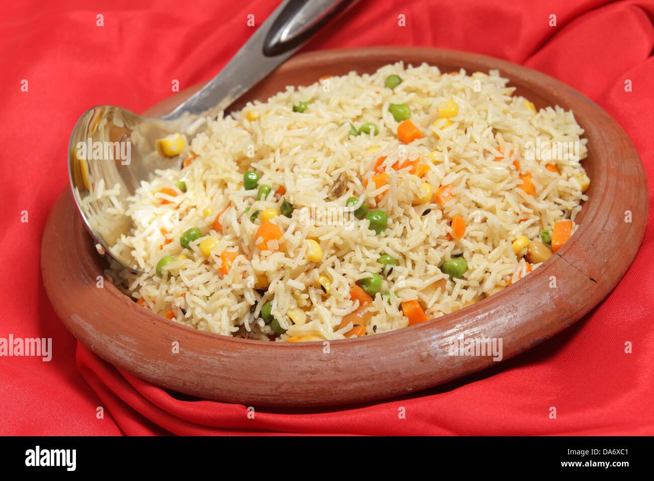 Vegetable pilau, or pulau, rice in an ethnic indian terracotta clay ...