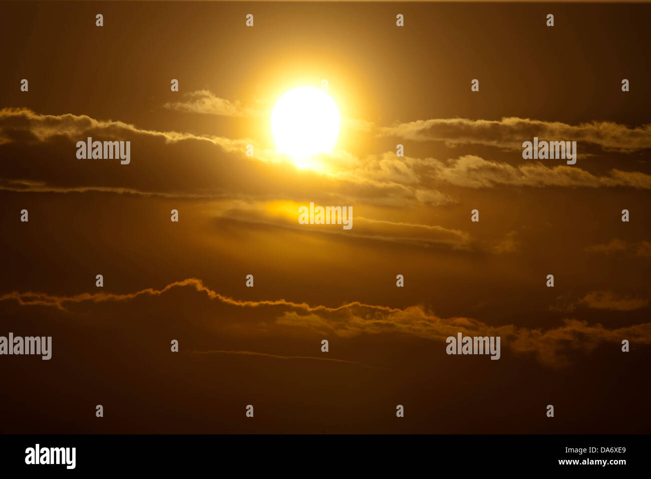 LARGE SUN ALONE SUNSET OVER CLOUDS Stock Photo - Alamy