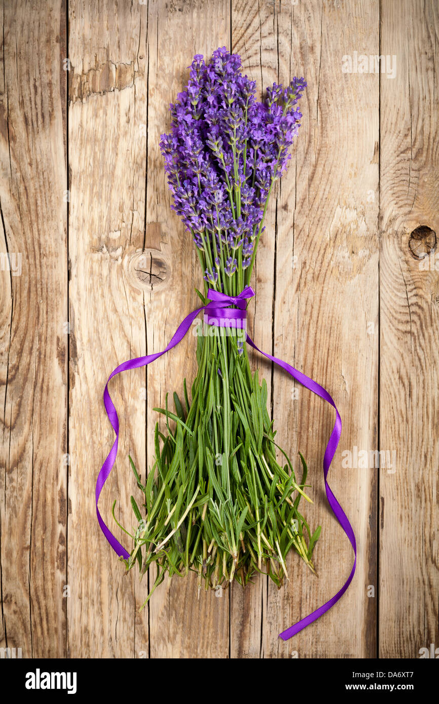 Lavender flowers on wooden table background. Top view Stock Photo - Alamy