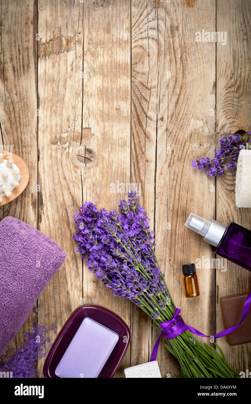 Lavender spa beauty treatment products on wooden table. Empty room for ...