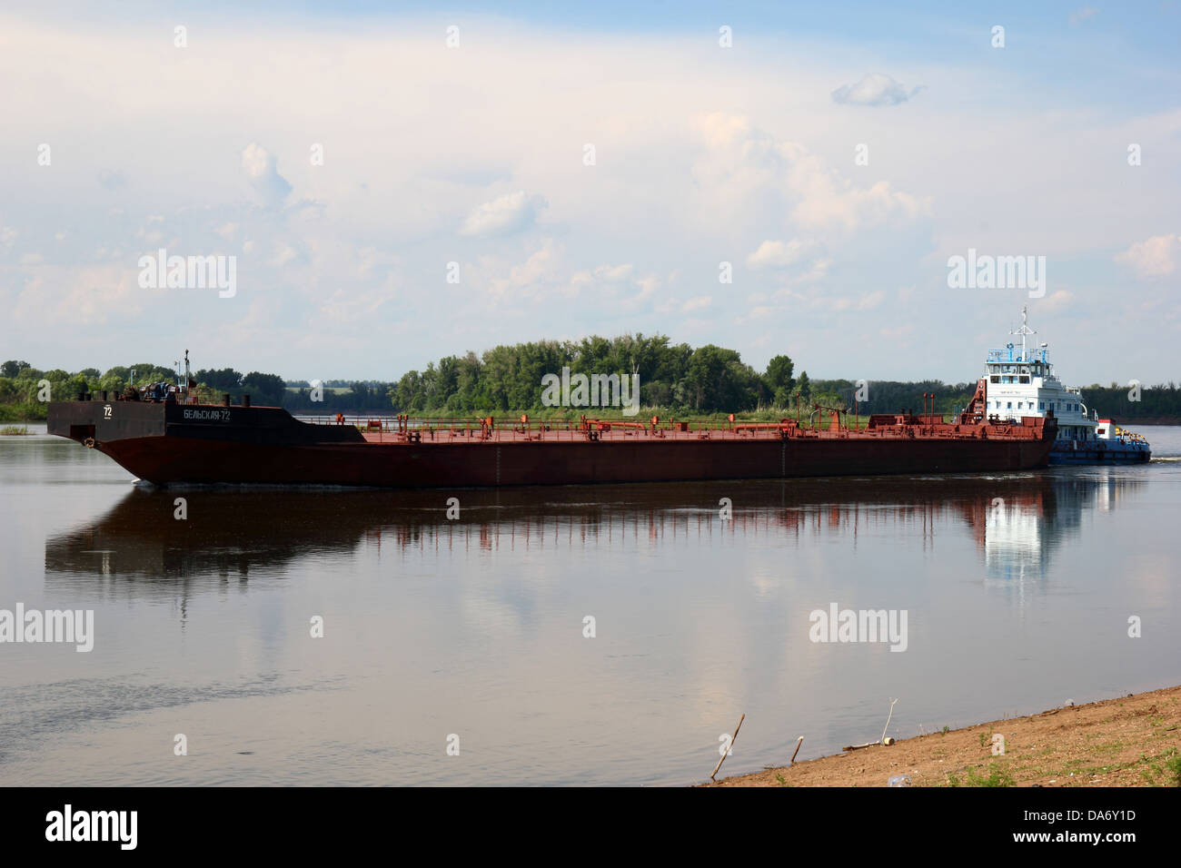 floating on the river barge on the background of blue sky Stock Photo ...
