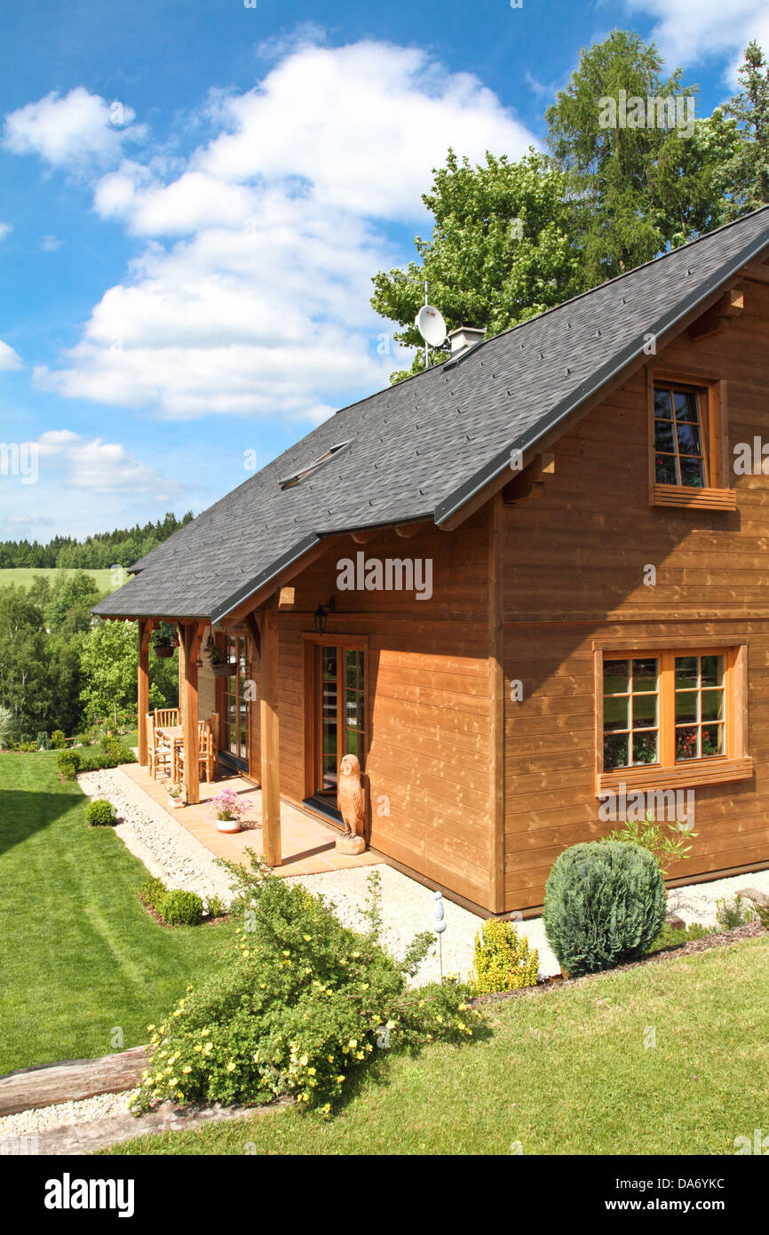 Modern wooden house in the garden Stock Photo - Alamy