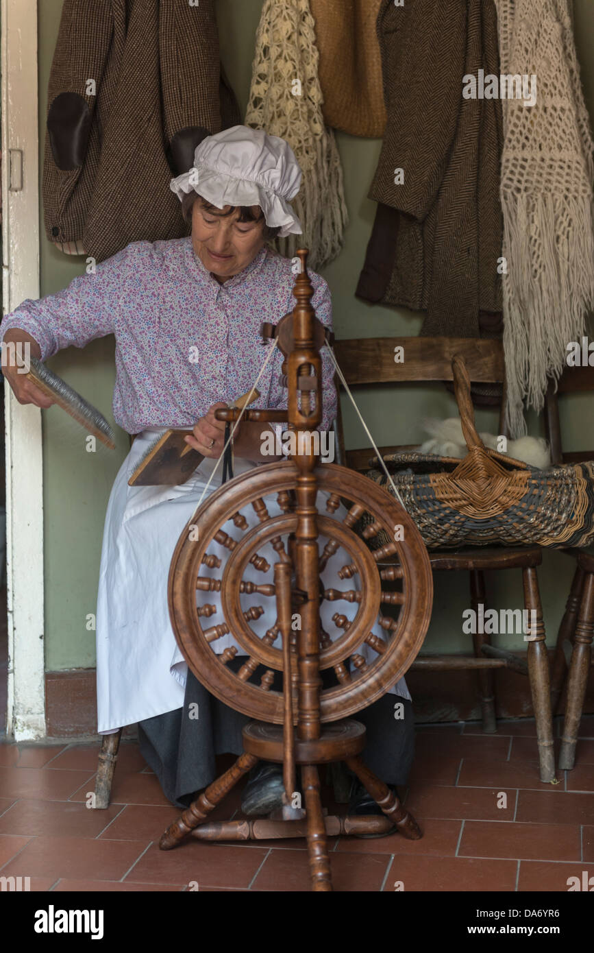A woman in Victorian costume hand spinning wool at Acton Scott Historic ...