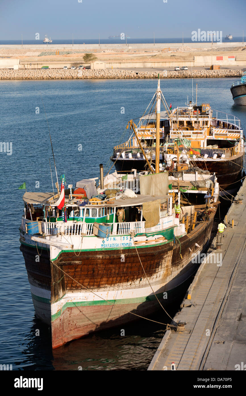 Oman, Salalah, Port, local wooden cargo dhows moored at quayside Stock ...