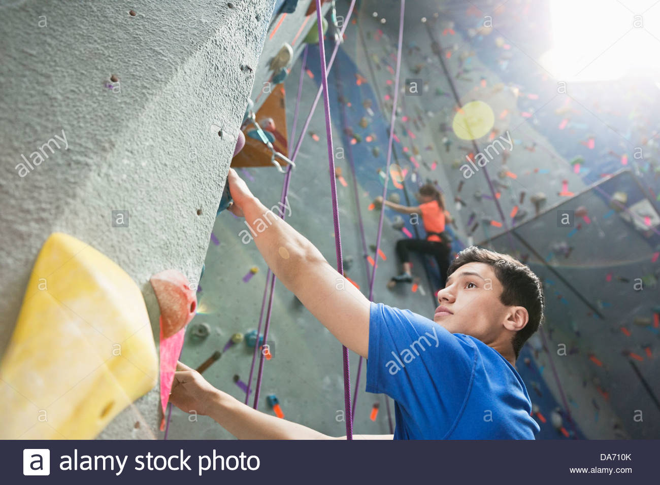 Two people climbing on climbing wall at gym Stock Photo - Alamy