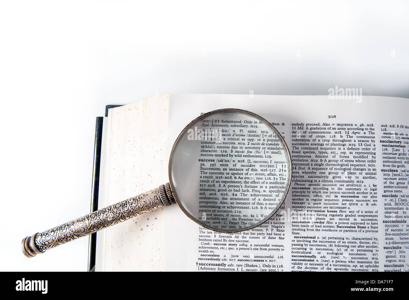 A magnifying glass on the word success on a dictionary Stock Photo - Alamy