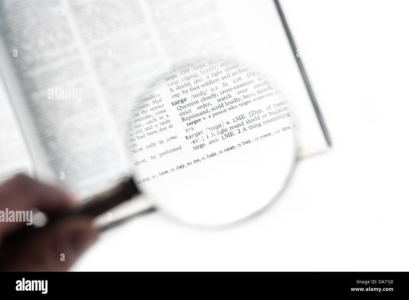A magnifying glass on the word target on a dictionary Stock Photo - Alamy