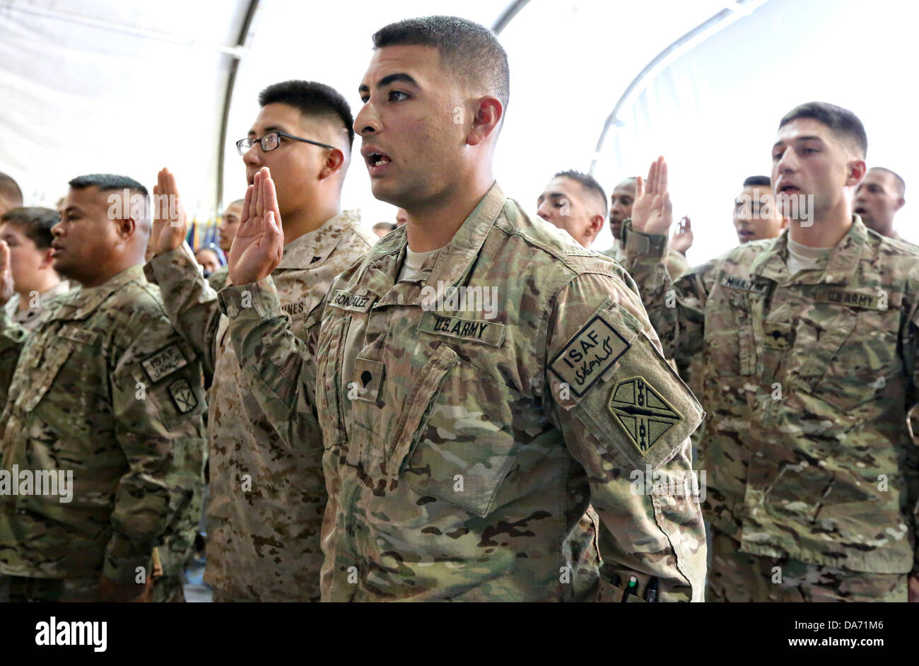US soldiers take the oath of allegiance at an Independence Day ...