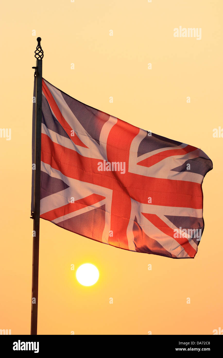 The sun rises behind the Union flag, or Union Jack, national flag of ...