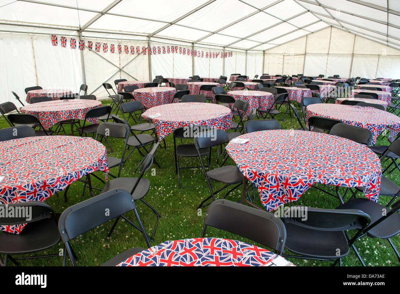 Union Jack lag table cloths under a Marquee Stock Photo - Alamy