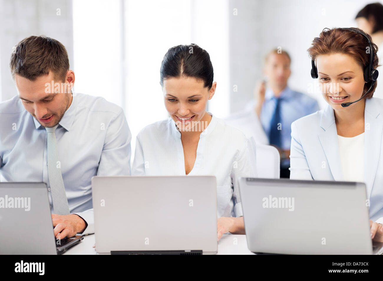group of people working with laptops in office Stock Photo - Alamy
