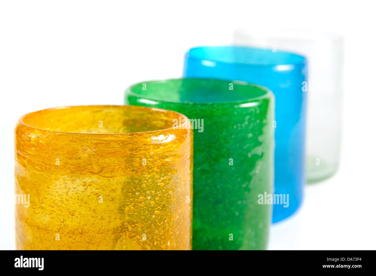 group of multi coloured glass cups on white background Stock Photo - Alamy