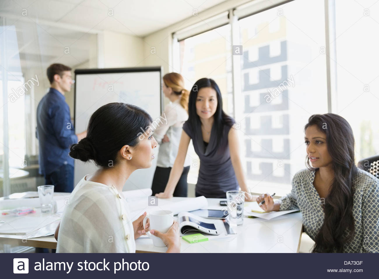 Business colleagues working on project in office Stock Photo - Alamy