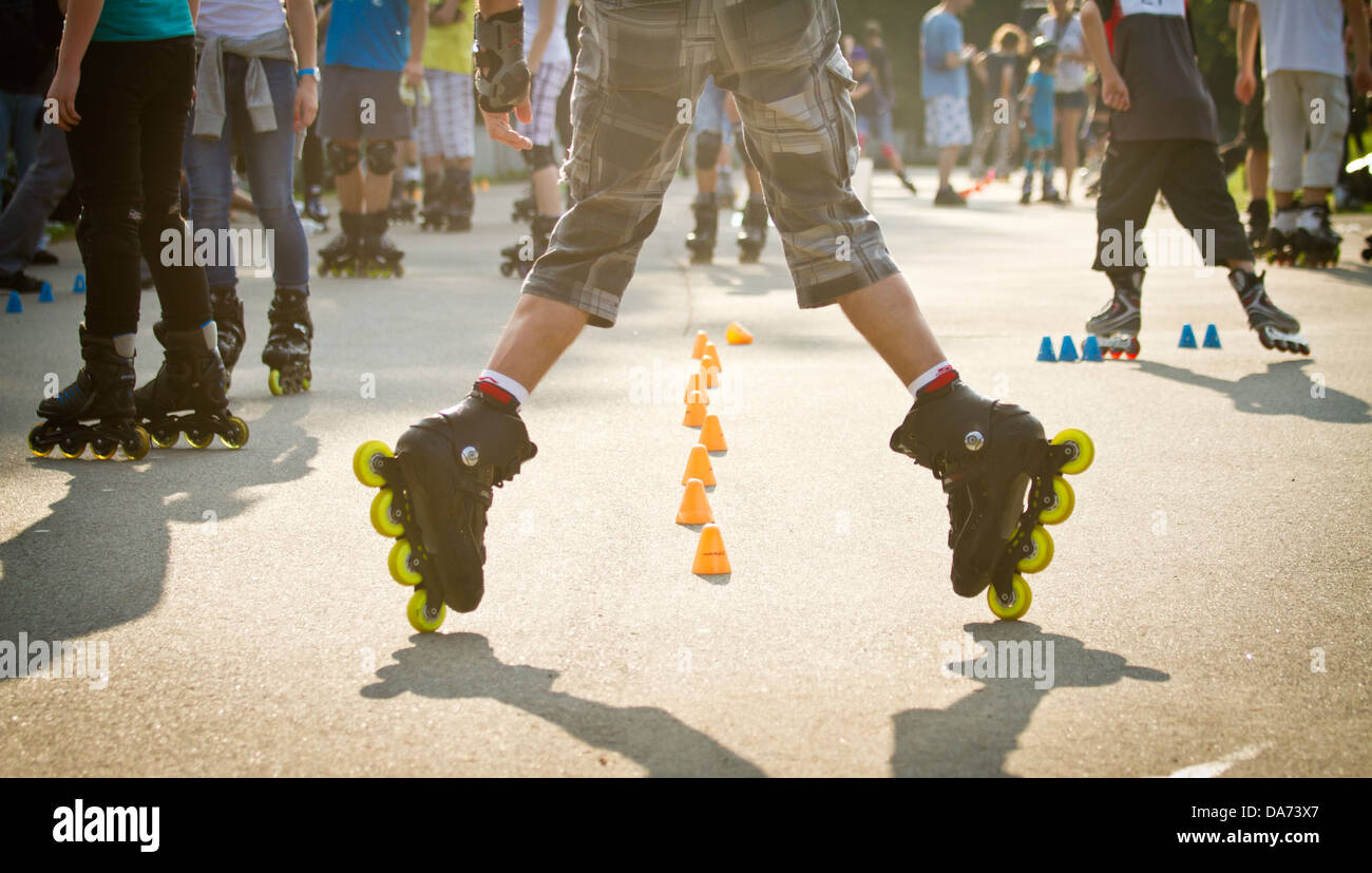 Man roller blading through slalom cones Stock Photo - Alamy