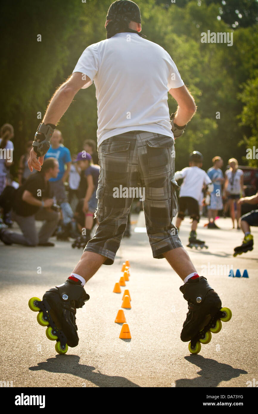 Man roller blading through slalom cones Stock Photo - Alamy