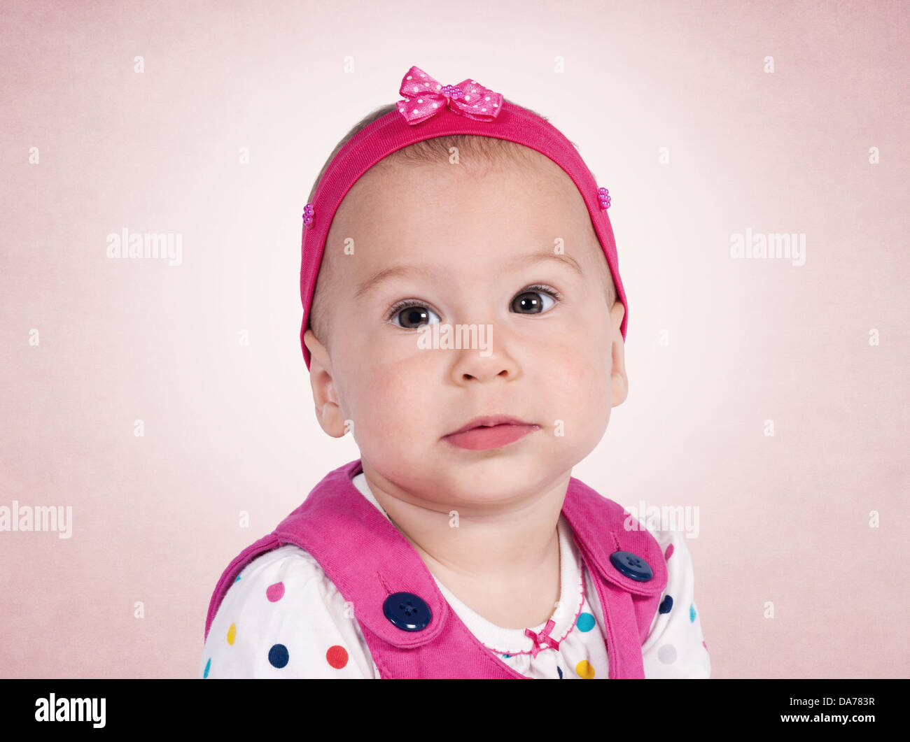 Portrait of pretty baby girl on pink background Stock Photo - Alamy