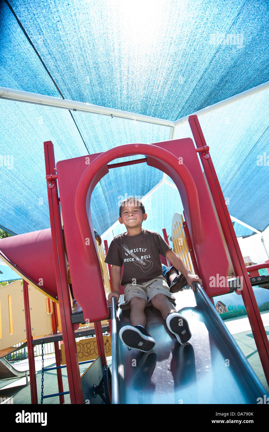 children playing on a playground slide hispanic asain caucasian Stock ...