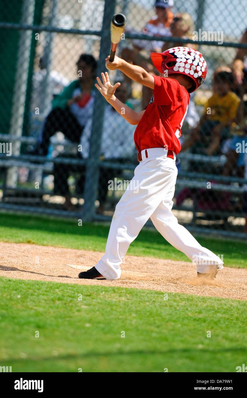 Young baseball boy swinging the bat Stock Photo - Alamy