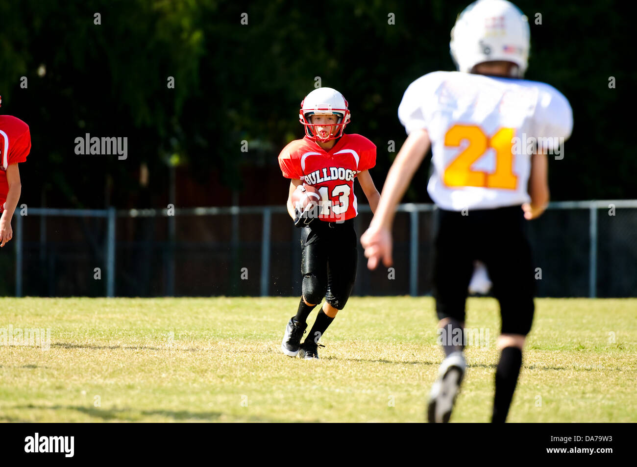 Youth football boy running the ball Stock Photo - Alamy