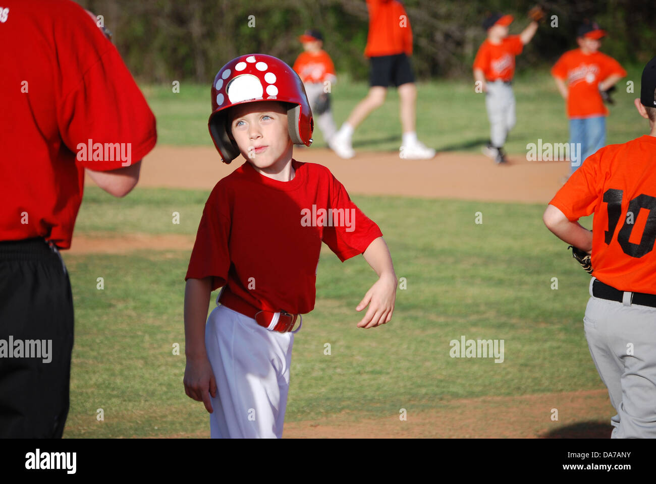 Cute baseball little league player smiling at coach Stock Photo - Alamy