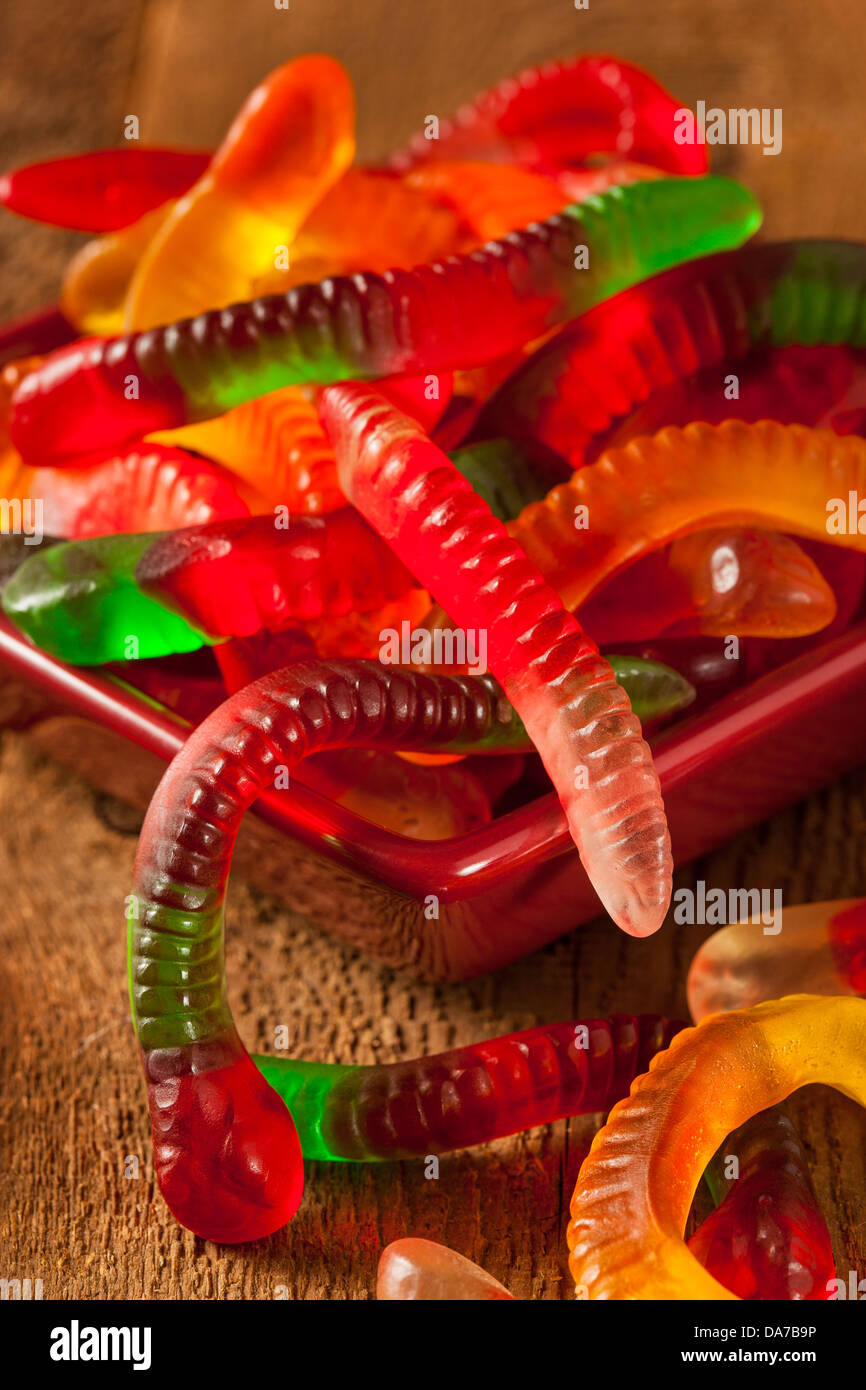 Colorful Fruity Gummy Worm Candy on a background Stock Photo - Alamy