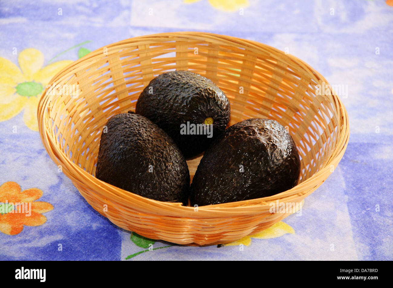 Three avocados in a wicker basket Stock Photo - Alamy