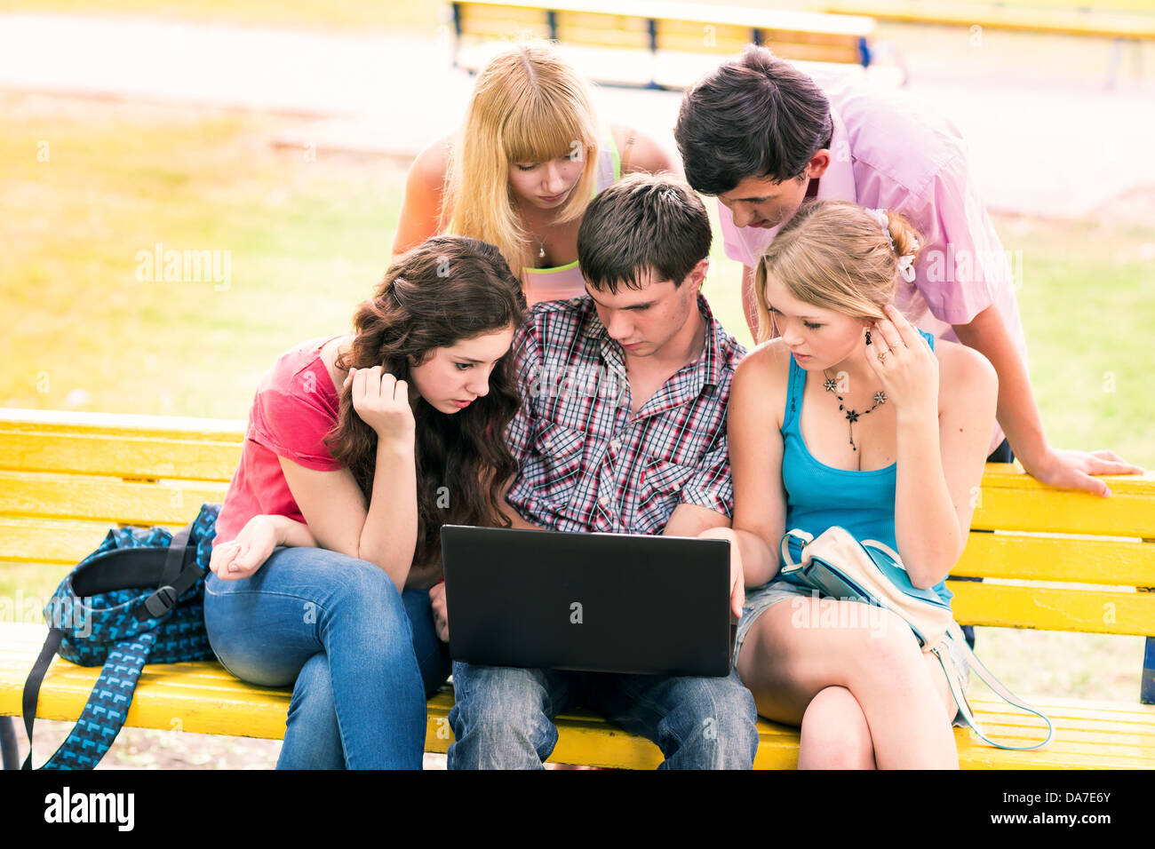 Group of happy smiling Teenage Students looking in laptop Stock Photo ...