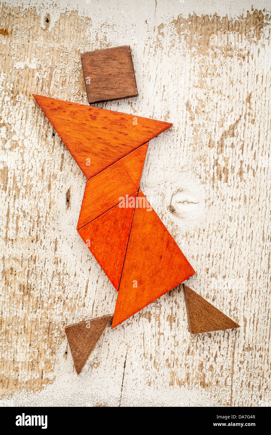 abstract figure of a female dancer built from seven tangram wooden ...