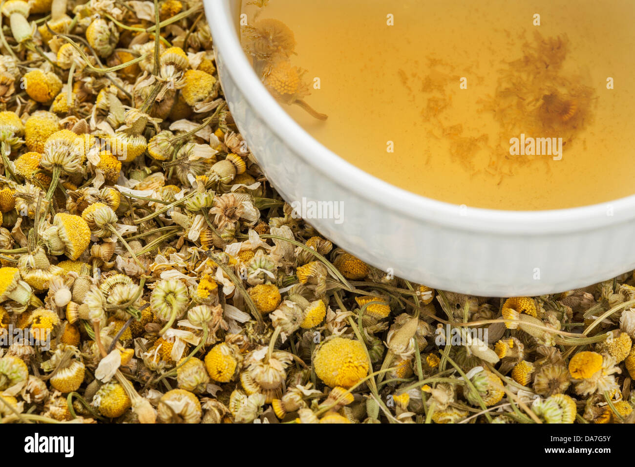 a cup of chamomile herbal tea with background of dry flowers Stock ...