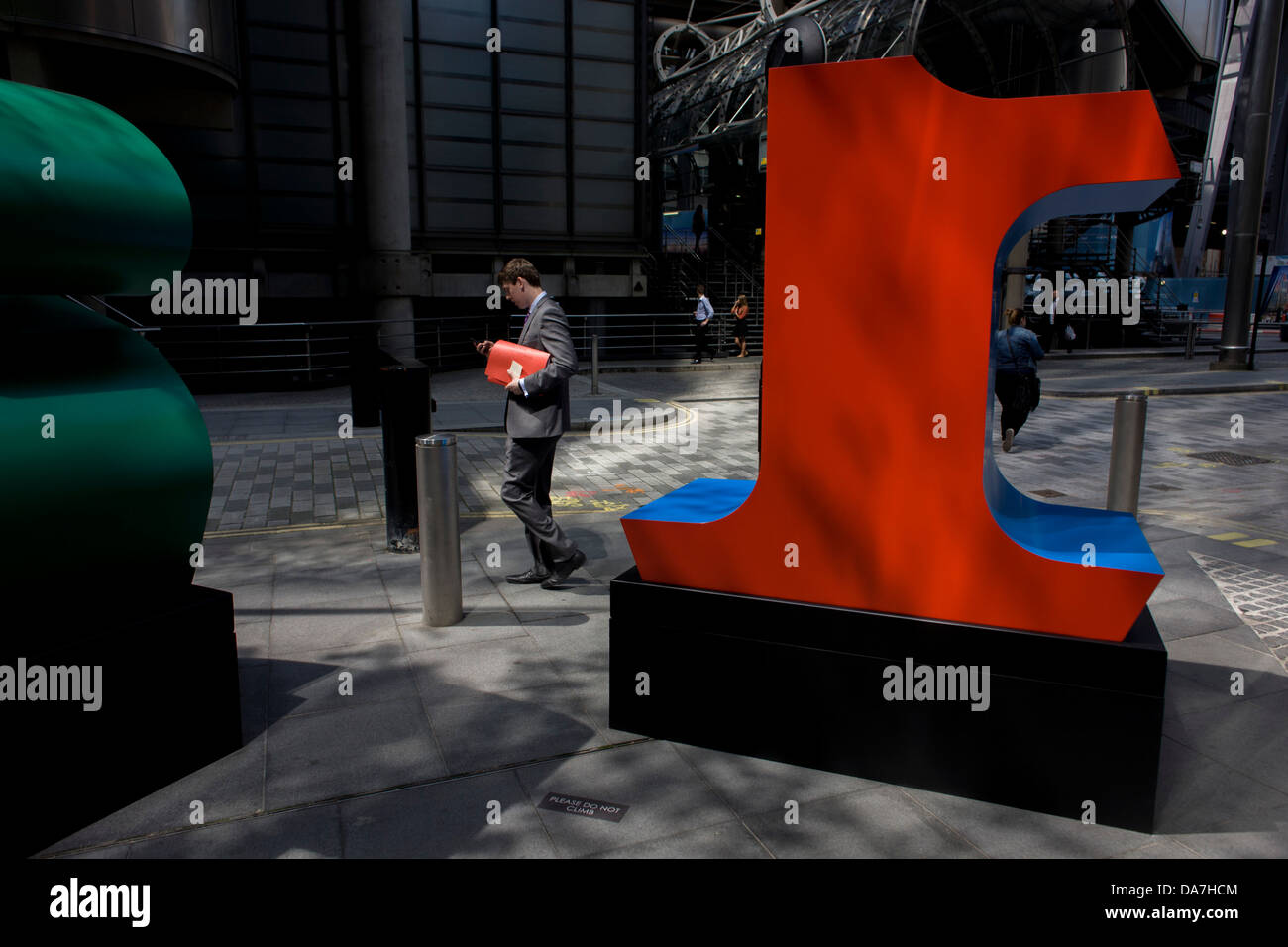 A city worker passes-by a large red number One, part of an art ...