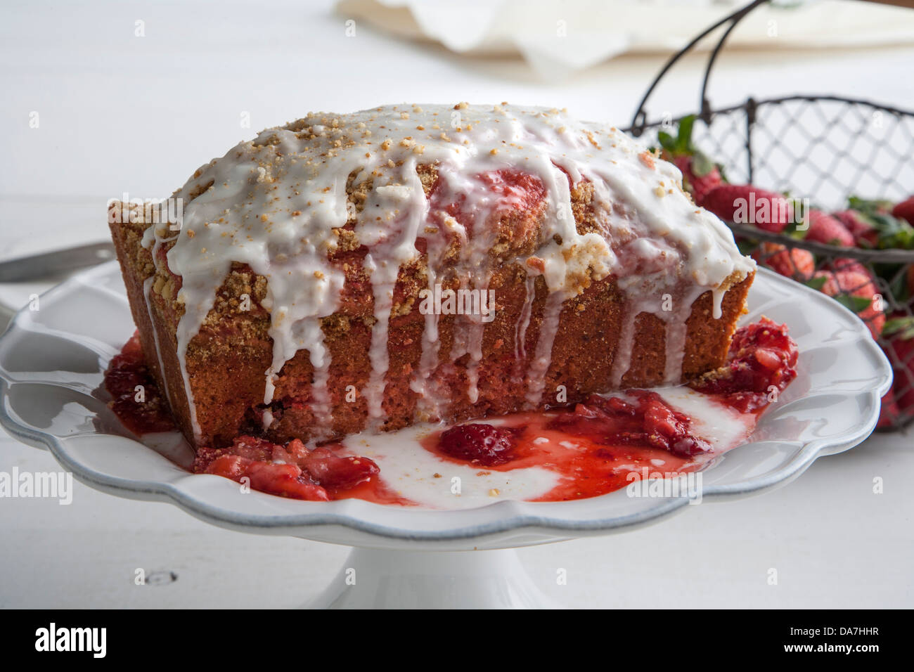 strawberry dessert bread with icing on a cake platter Stock Photo - Alamy