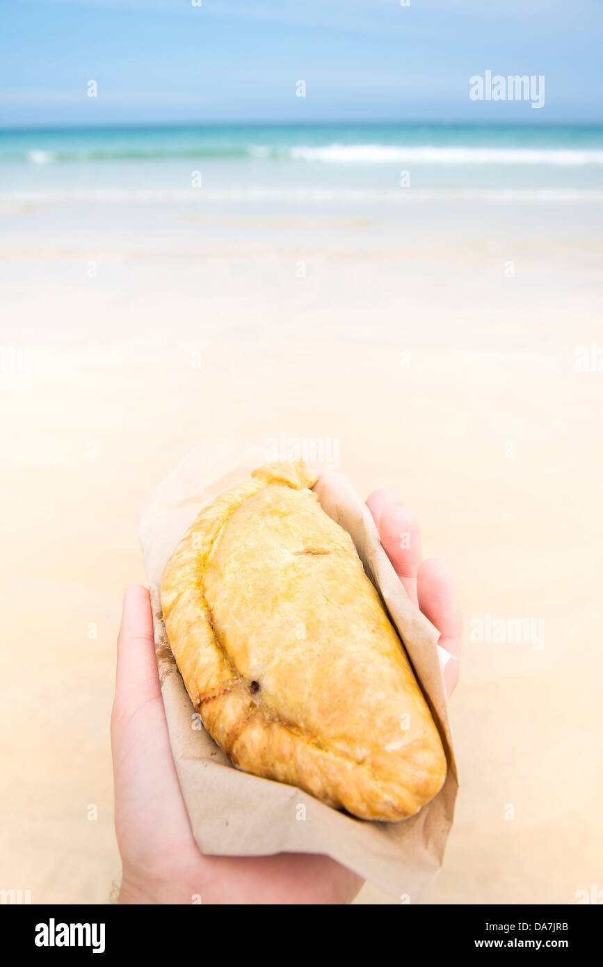 Hand holding (photographers hand) Cornish Pasty on Porthmeor Beach, St ...
