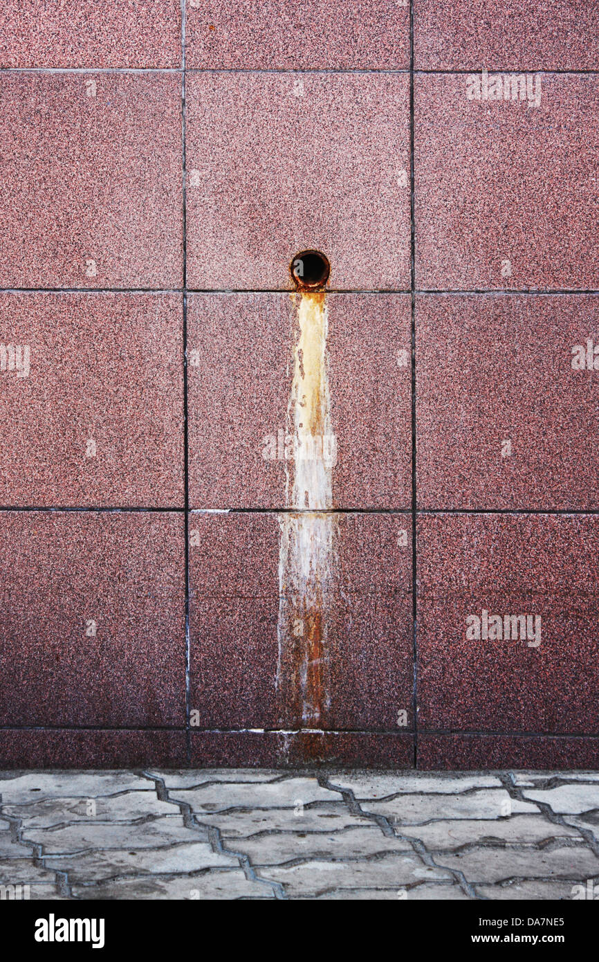 Drain pipe in a decorative granite wall Stock Photo - Alamy