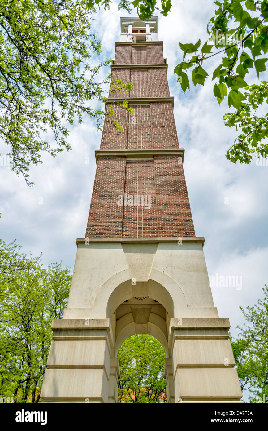 Nature surrounds a classic clock tower made of brisk Stock Photo - Alamy