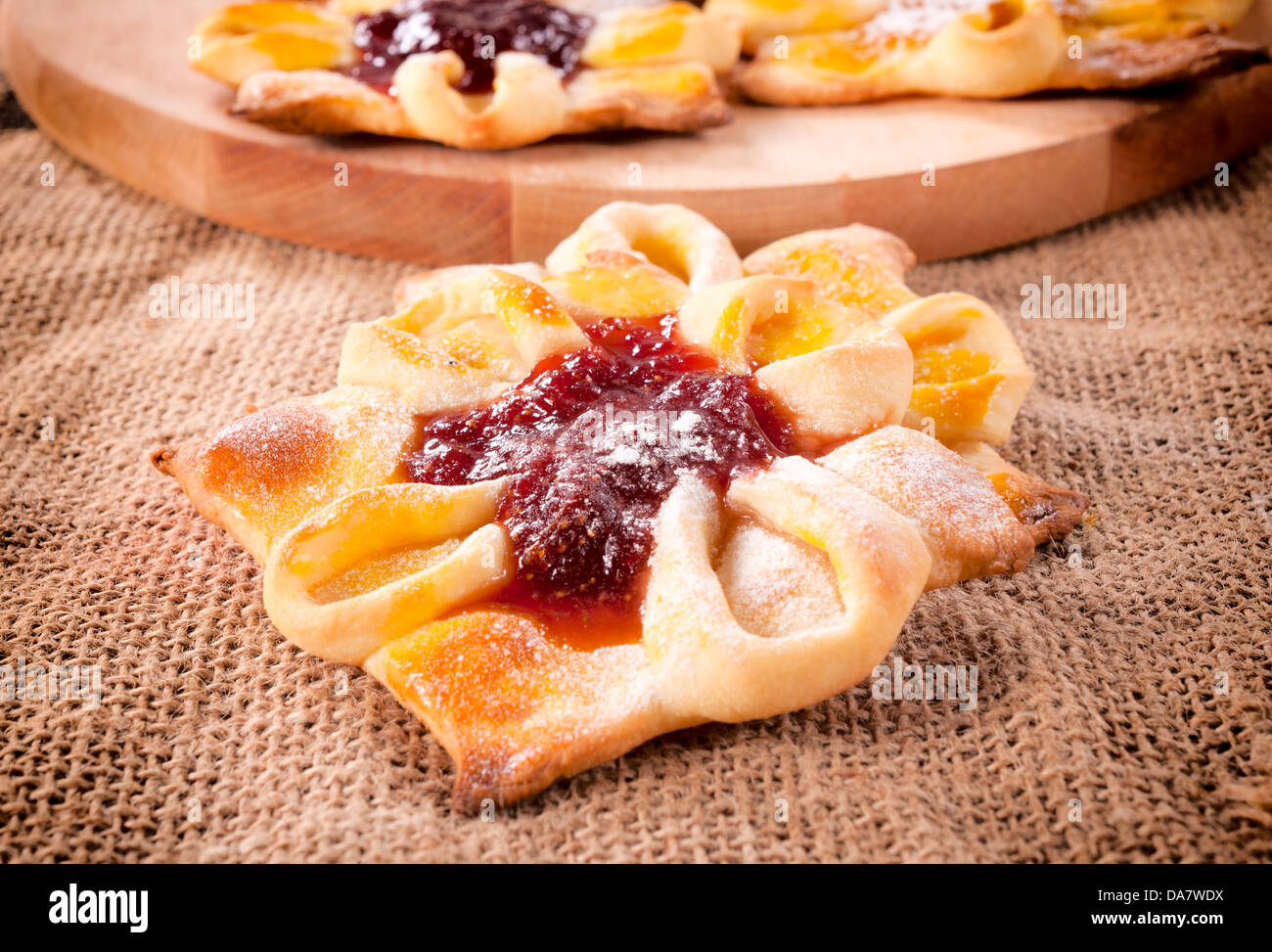 Baked pastry with strawberries jam and sugar on the top Stock Photo - Alamy
