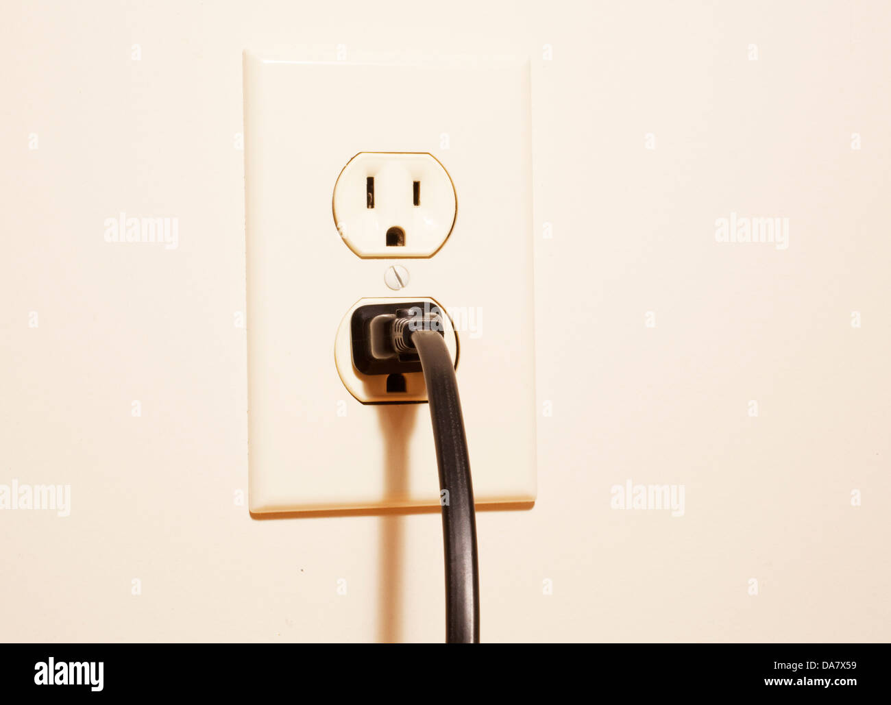 A plug connected to an electrical outlet Stock Photo - Alamy