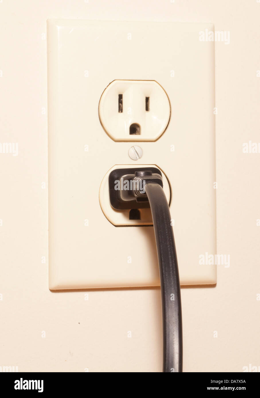 A plug connected to an electrical outlet Stock Photo - Alamy