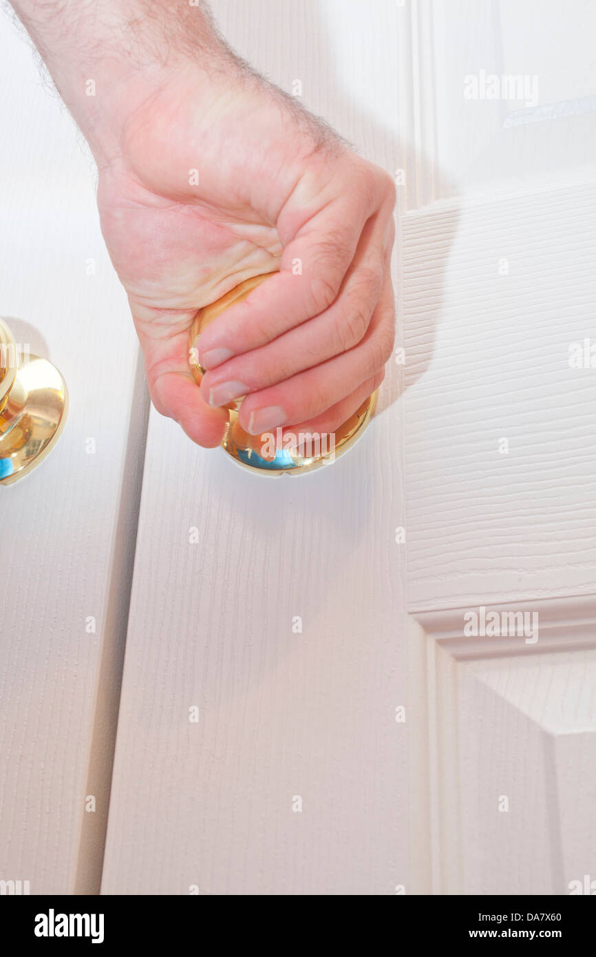 A hand grabbing a door knob Stock Photo - Alamy