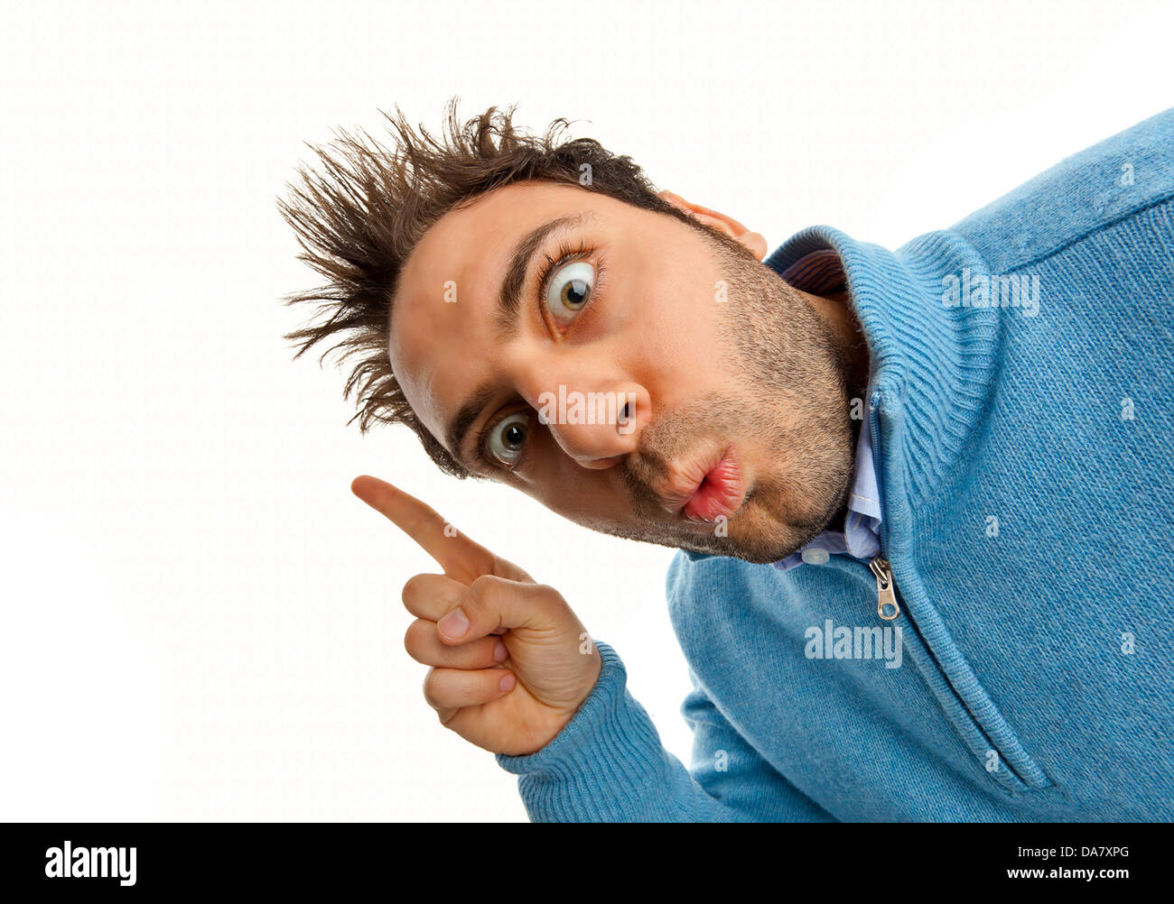 Young boy with a surprised expression pointing on white background ...