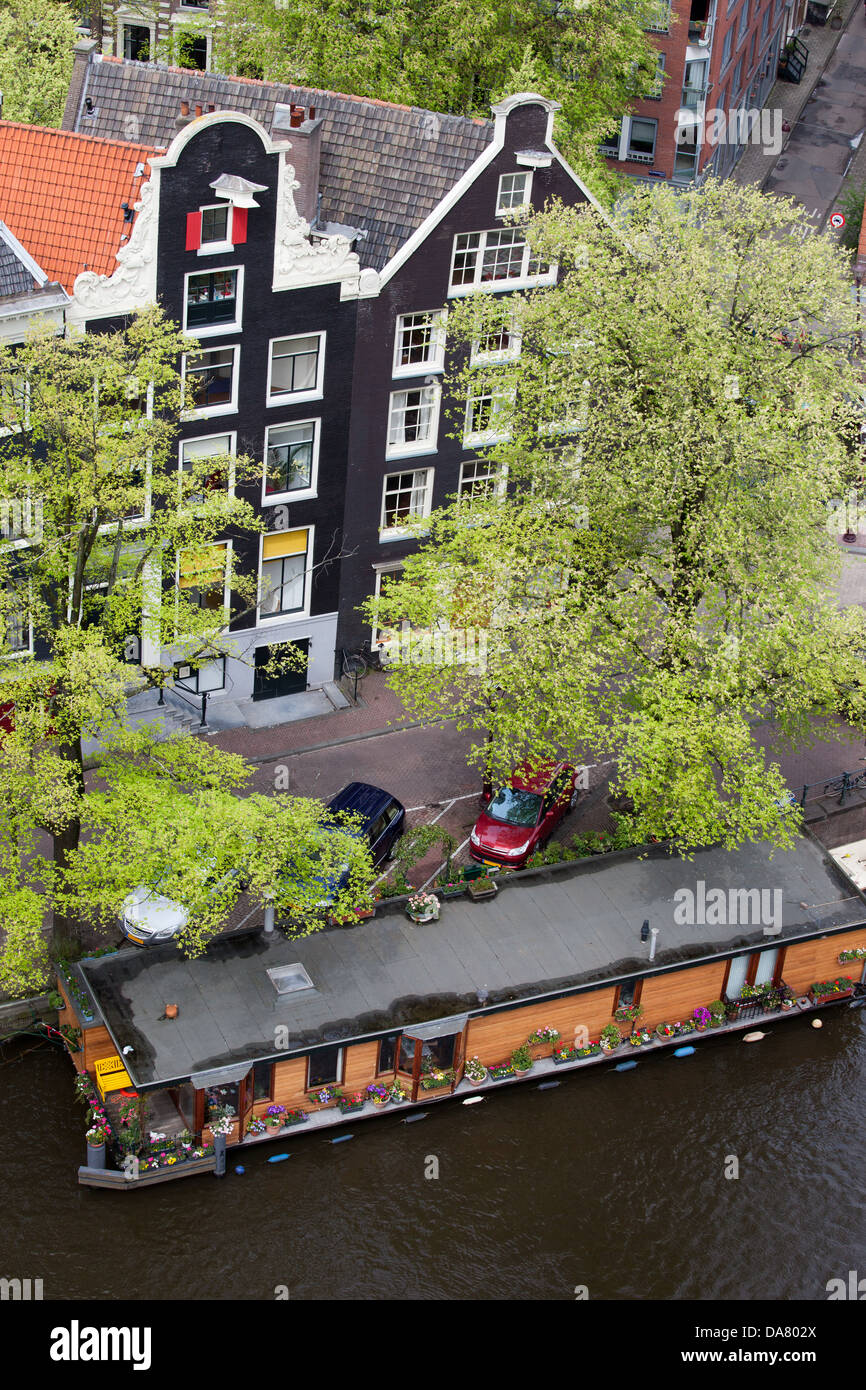 City of Amsterdam traditional Dutch style houses and a houseboat on a ...