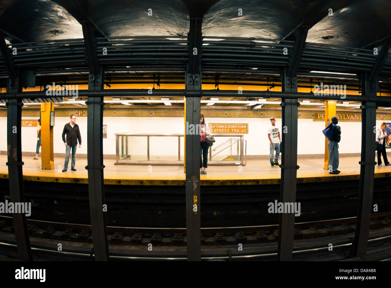 Commuters wait at subway platform at Pennsylvania Station NYC Stock Photo - Alamy