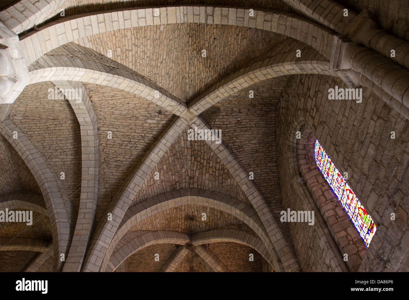 Stone arches support the ceiling of the Basilica of St-Sauveur in ...