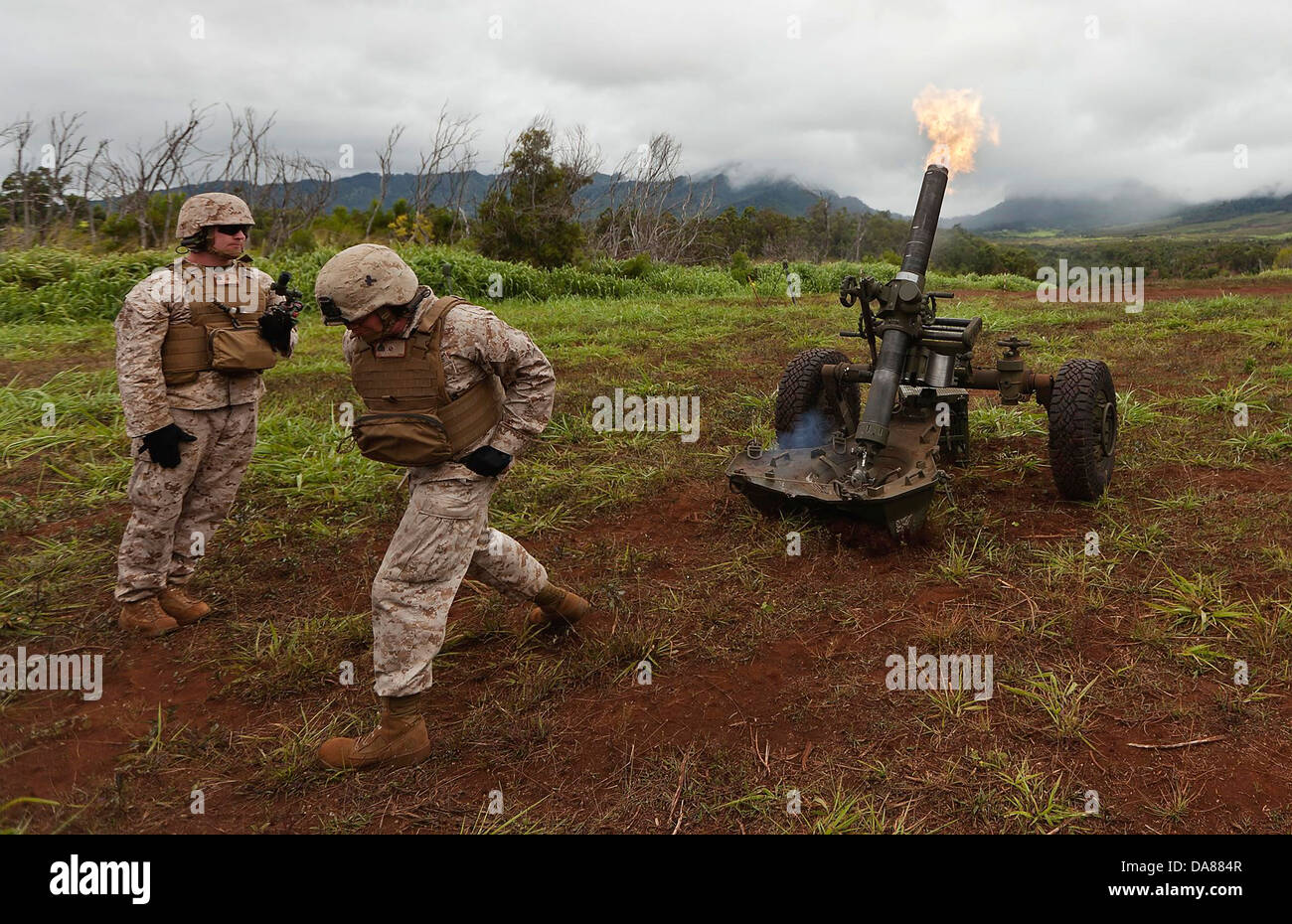 US Marines pull the lanyard to ignite an M327 Towed Rifle mortar system ...