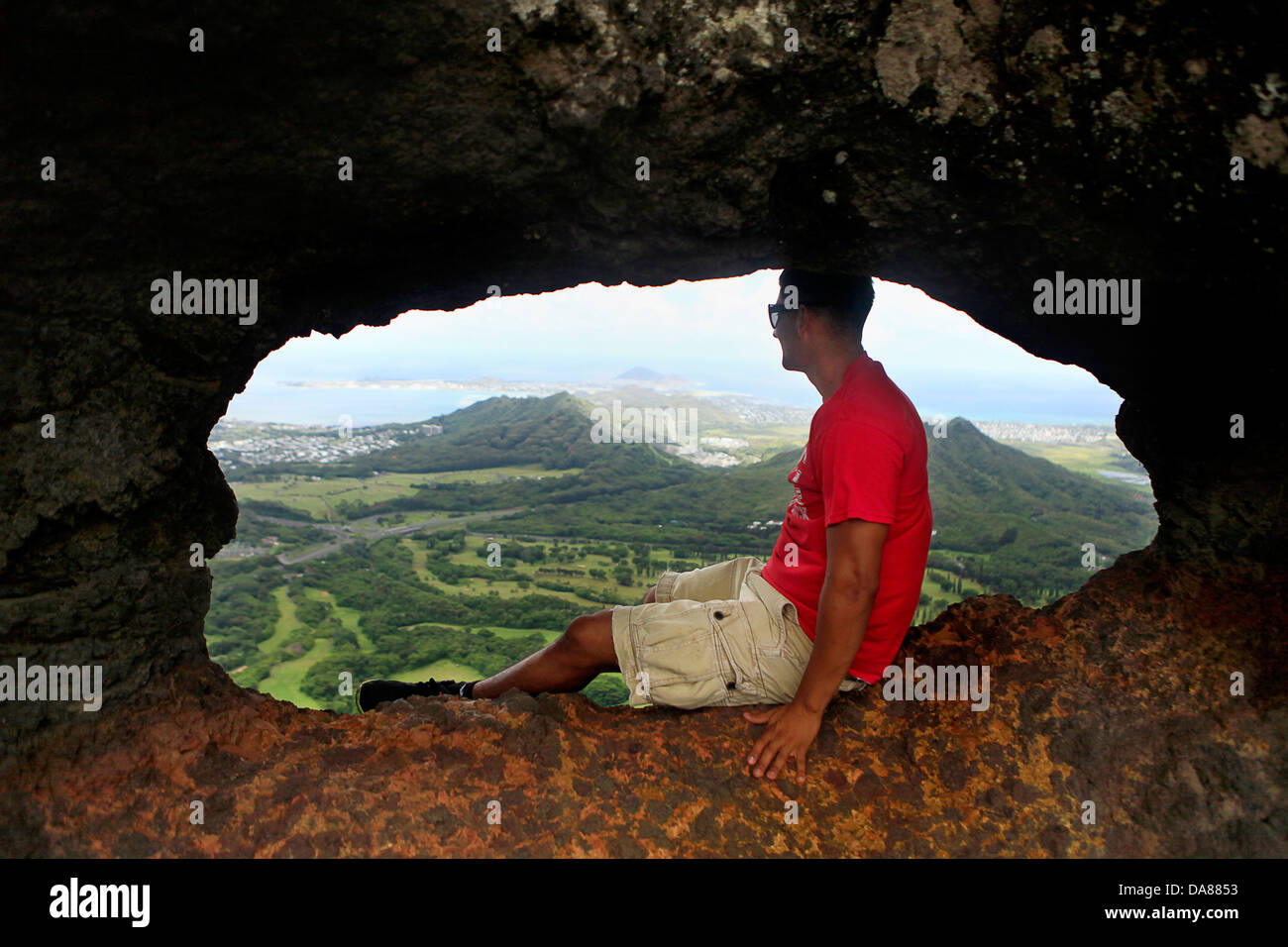 A hiker takes in the view of the Nuuanu Valley from the Pali Puka, a ...