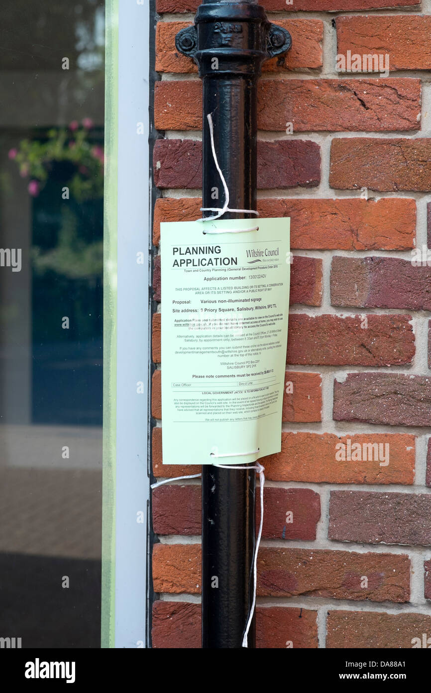 UK planning application notice tied to a drain pipe with white string ...