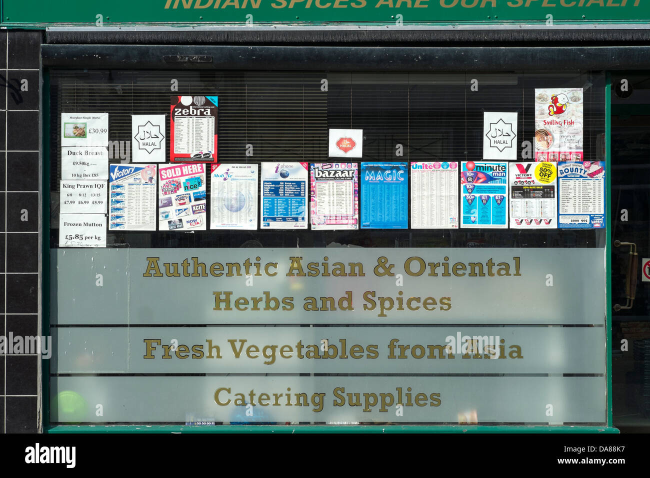 Posters in an Asian grocery shop window UK Stock Photo - Alamy